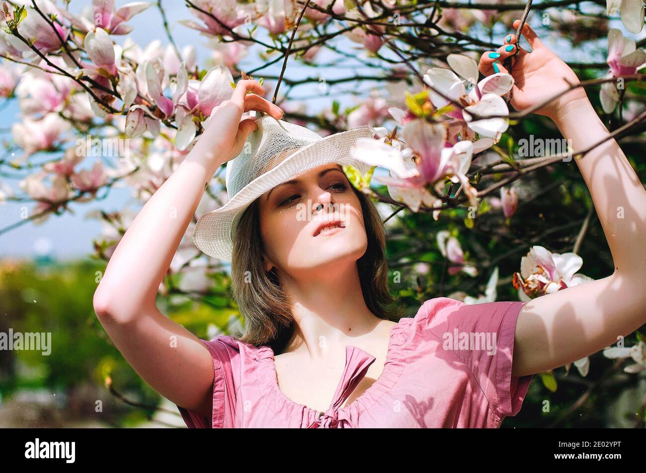 Portrait of young attractive woman in spring garden with blooming ...