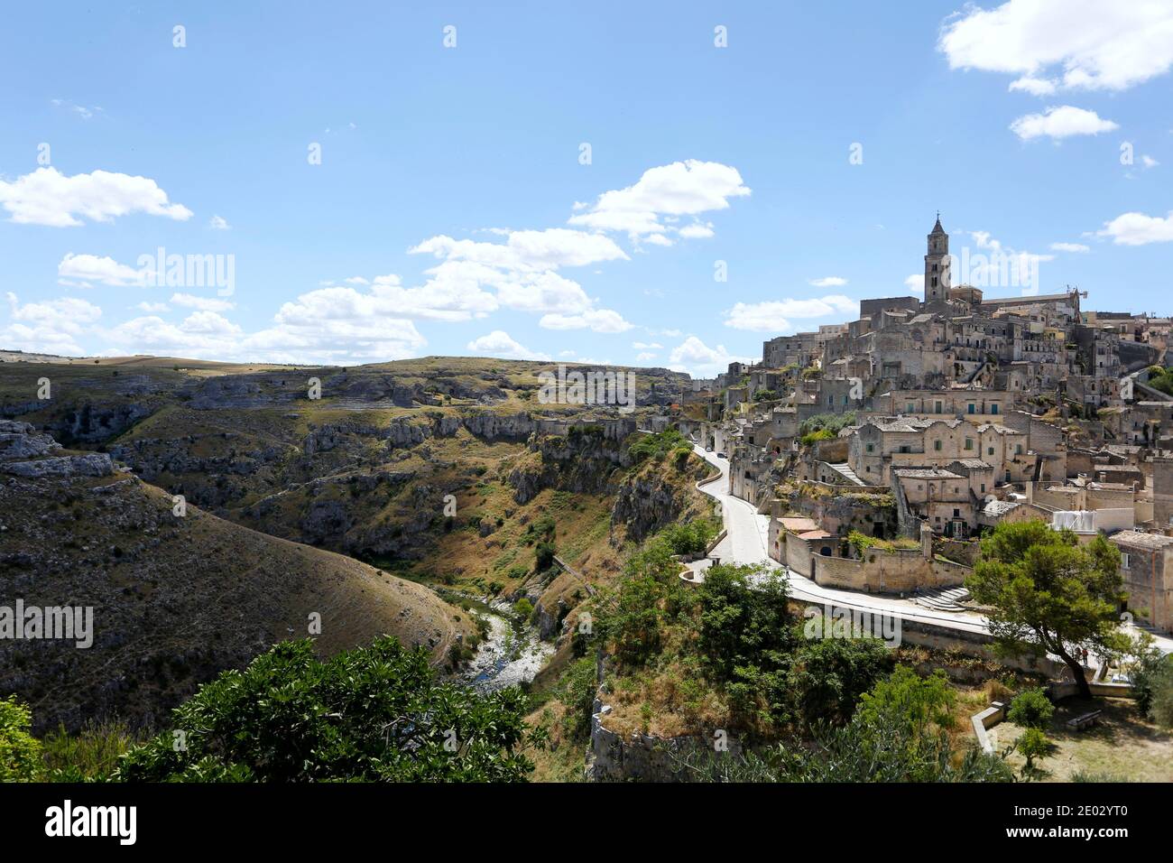 Scenic landscape of mountains, rocks and Matera sassi city with blue ...