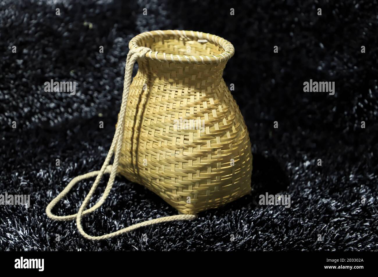 Side view of woven bamboo back basket for fishing with black background ...
