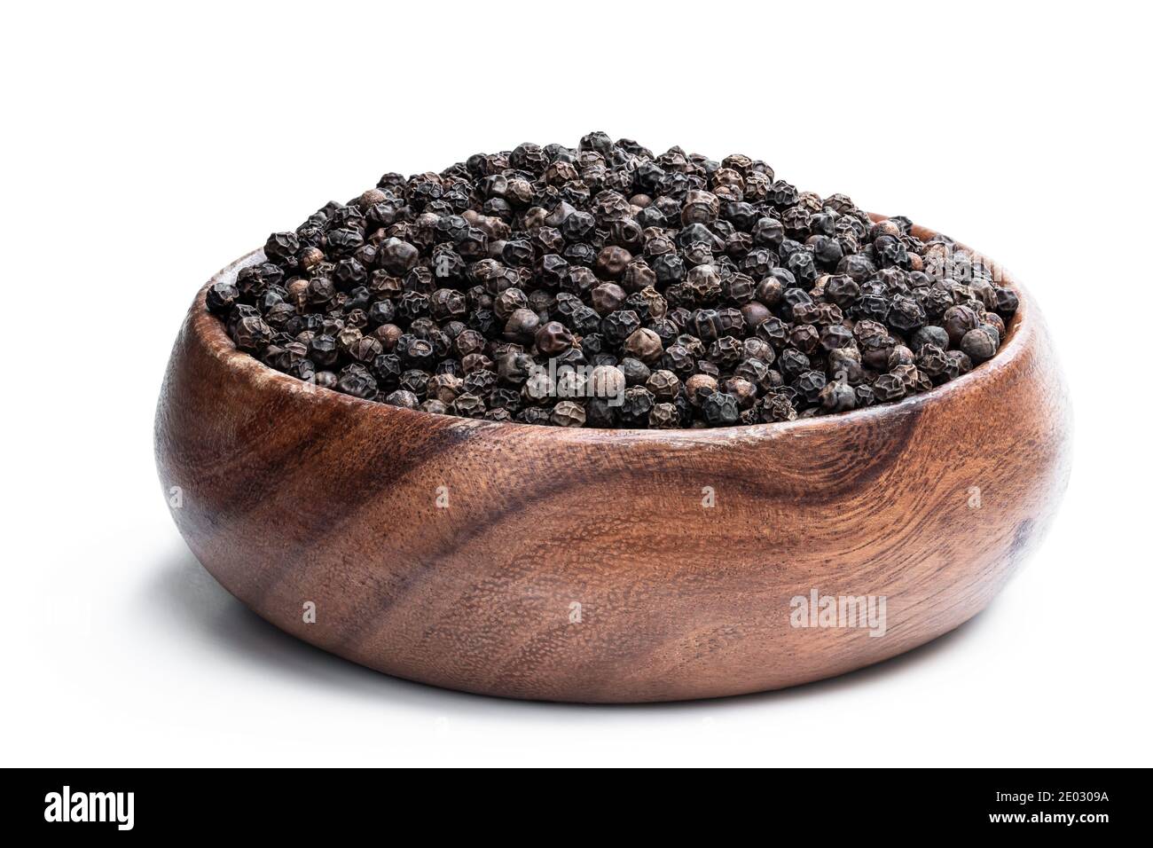 Black pepper corn in wooden bowl isolated on white Stock Photo - Alamy