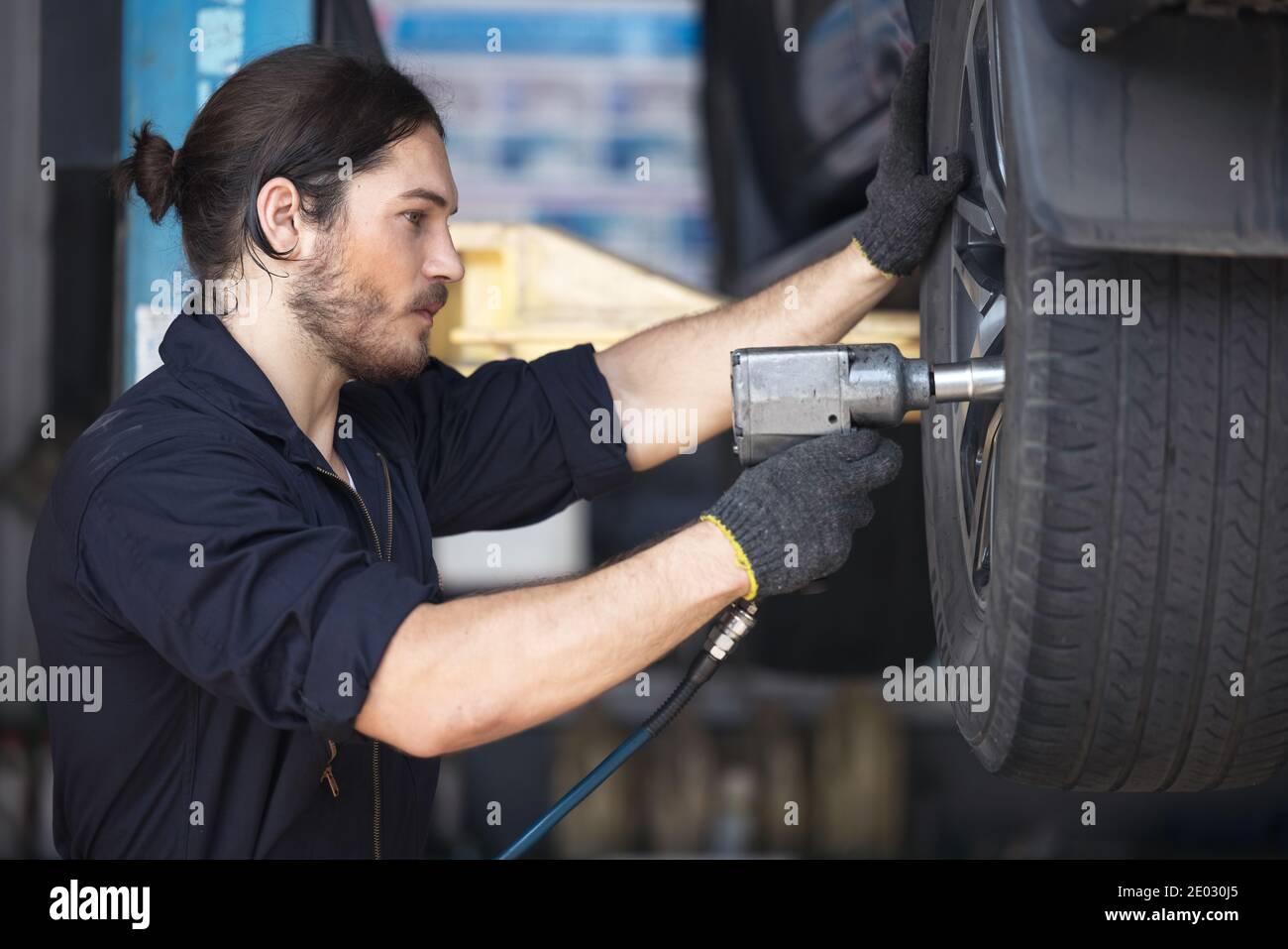 Mechanics Fixing Car Tires At Garage Stock Photo - Alamy