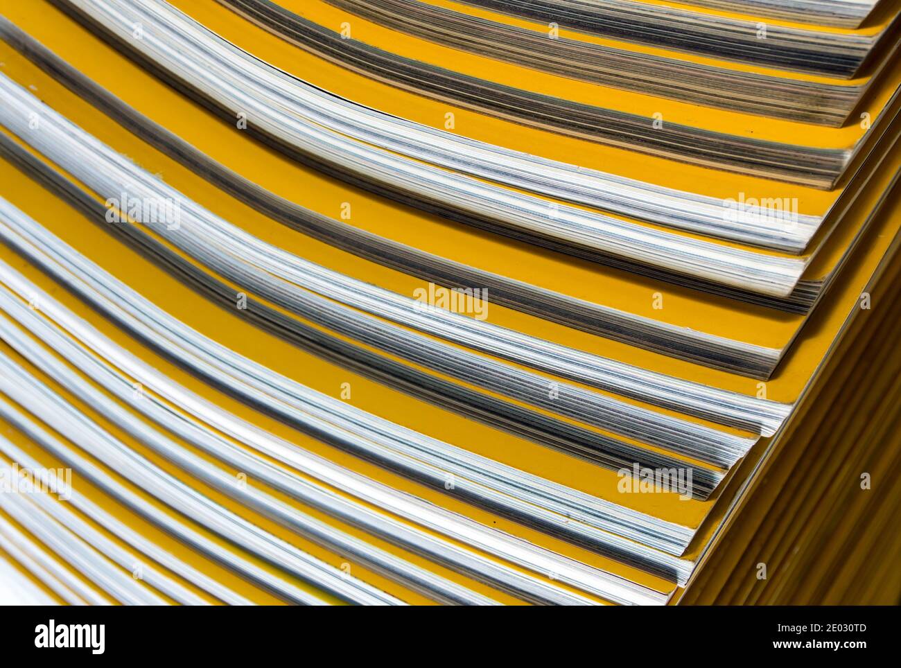 Stack of yellow color monthly magazine Stock Photo - Alamy