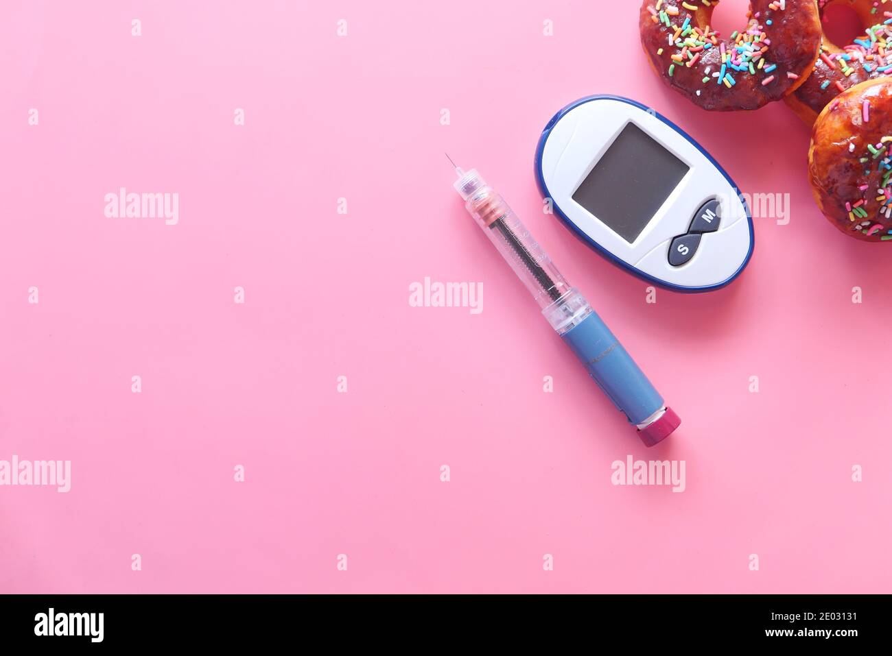 diabetic measurement tools, insulin and donuts on pink Stock Photo - Alamy