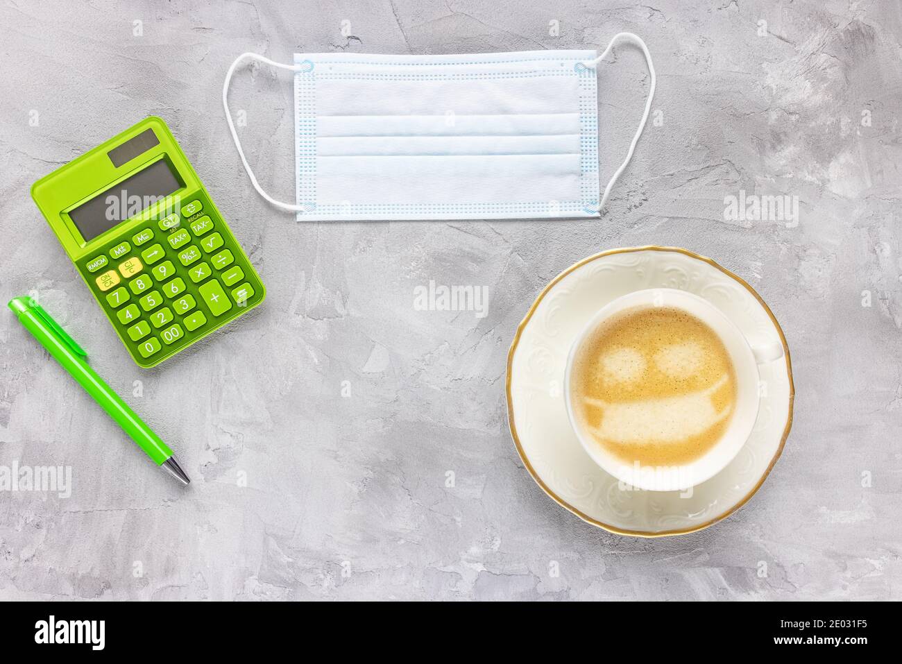Medical face mask, calculator, pen, cup of coffee Stock Photo - Alamy