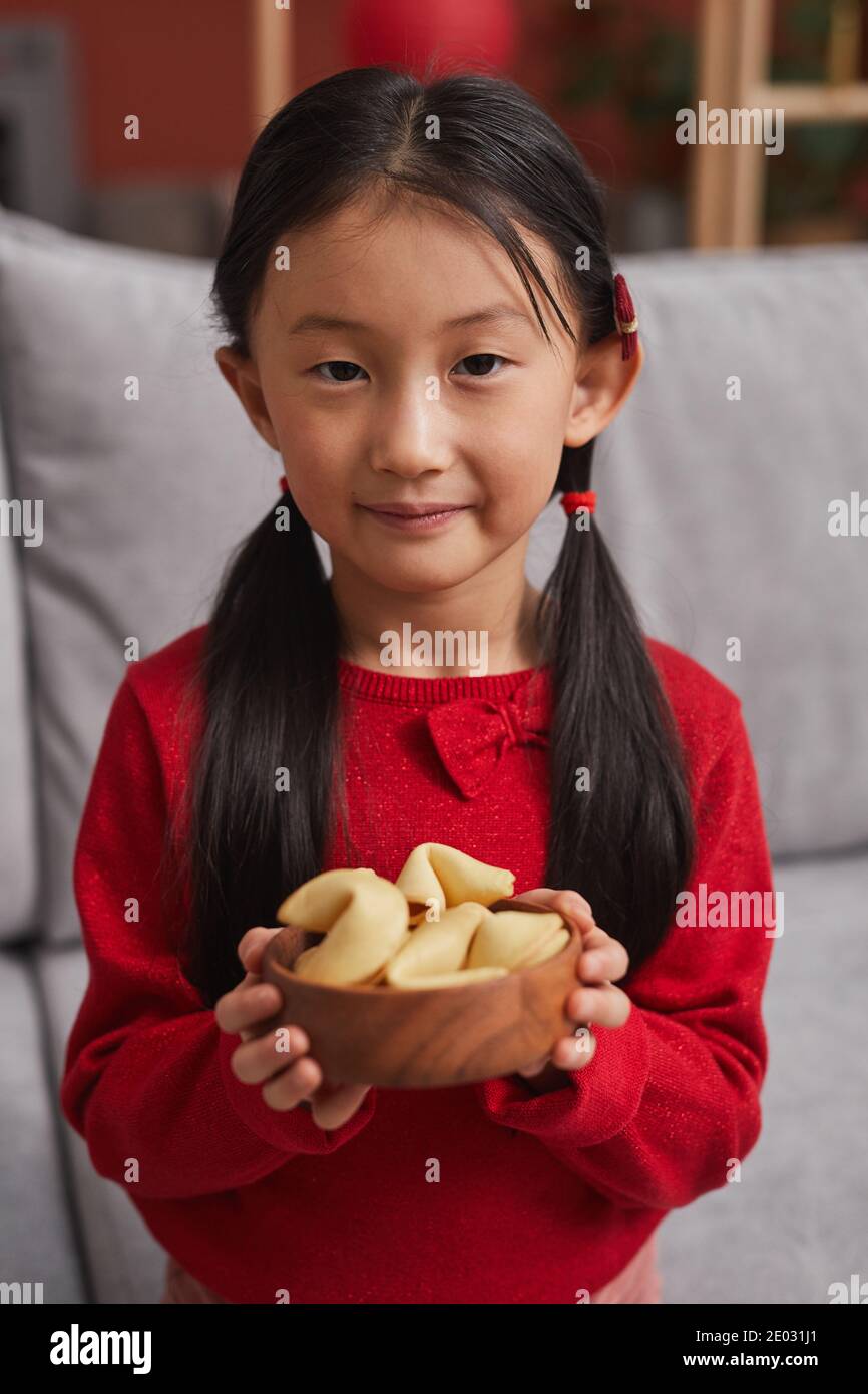 Waist up portrait shot of pretty little Chinese girl with two ponytails ...