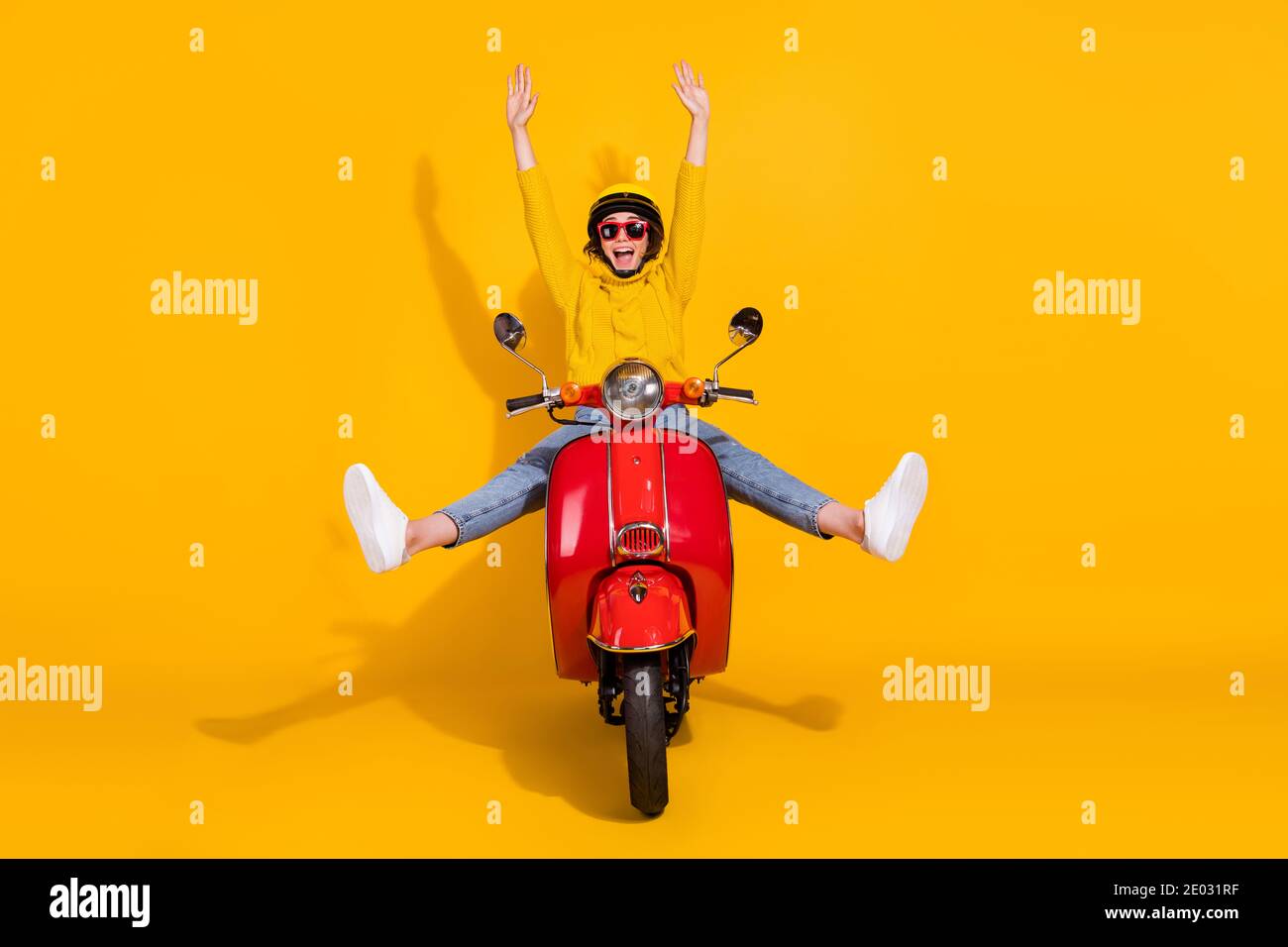 Photo portrait of girl riding red scooter not holding handlebars ...