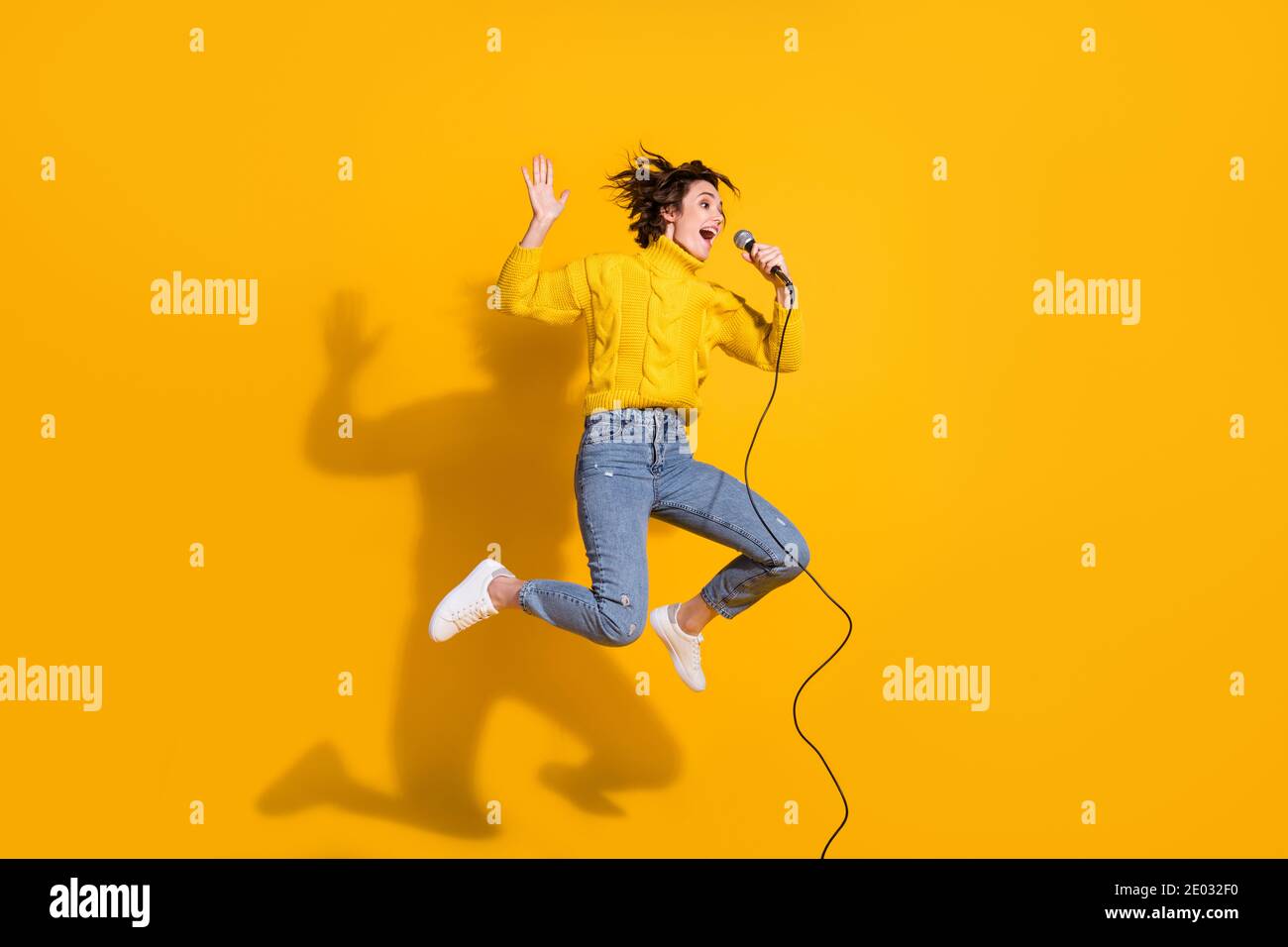 Full length body size photo of jumping female pop star singing in ...