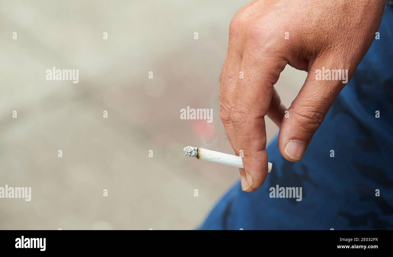 Detail of hand with cigarette Stock Photo - Alamy