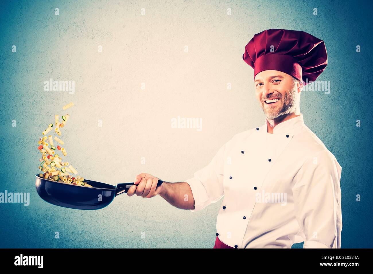 Chef cooking pasta on a skillet Stock Photo - Alamy