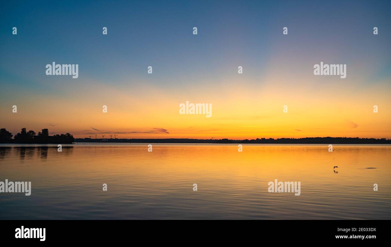 Golden sunbeams reflecting on the sea at sunrise Stock Photo - Alamy