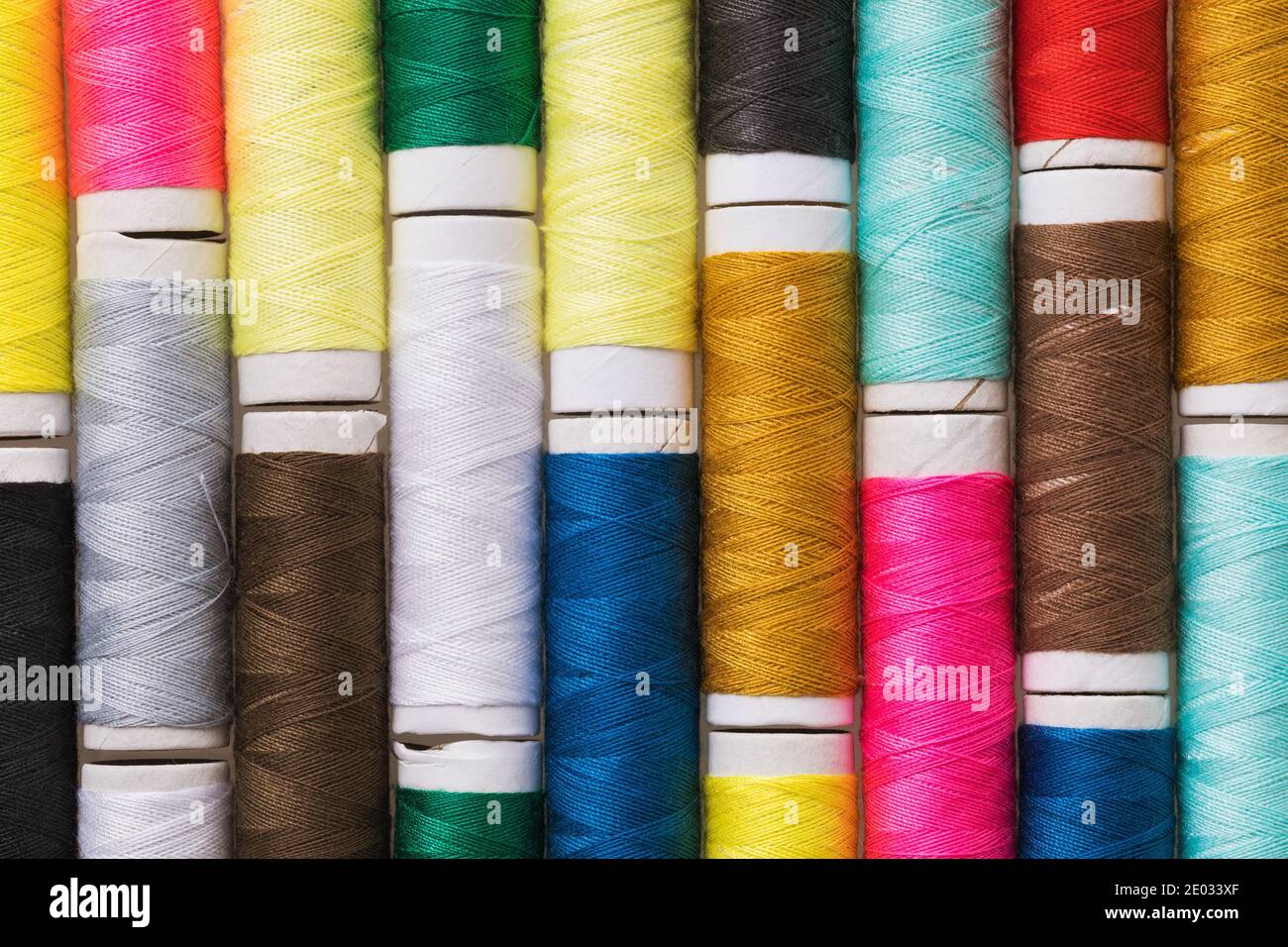 Background from multi-colored spools of thread, close-up Stock Photo ...