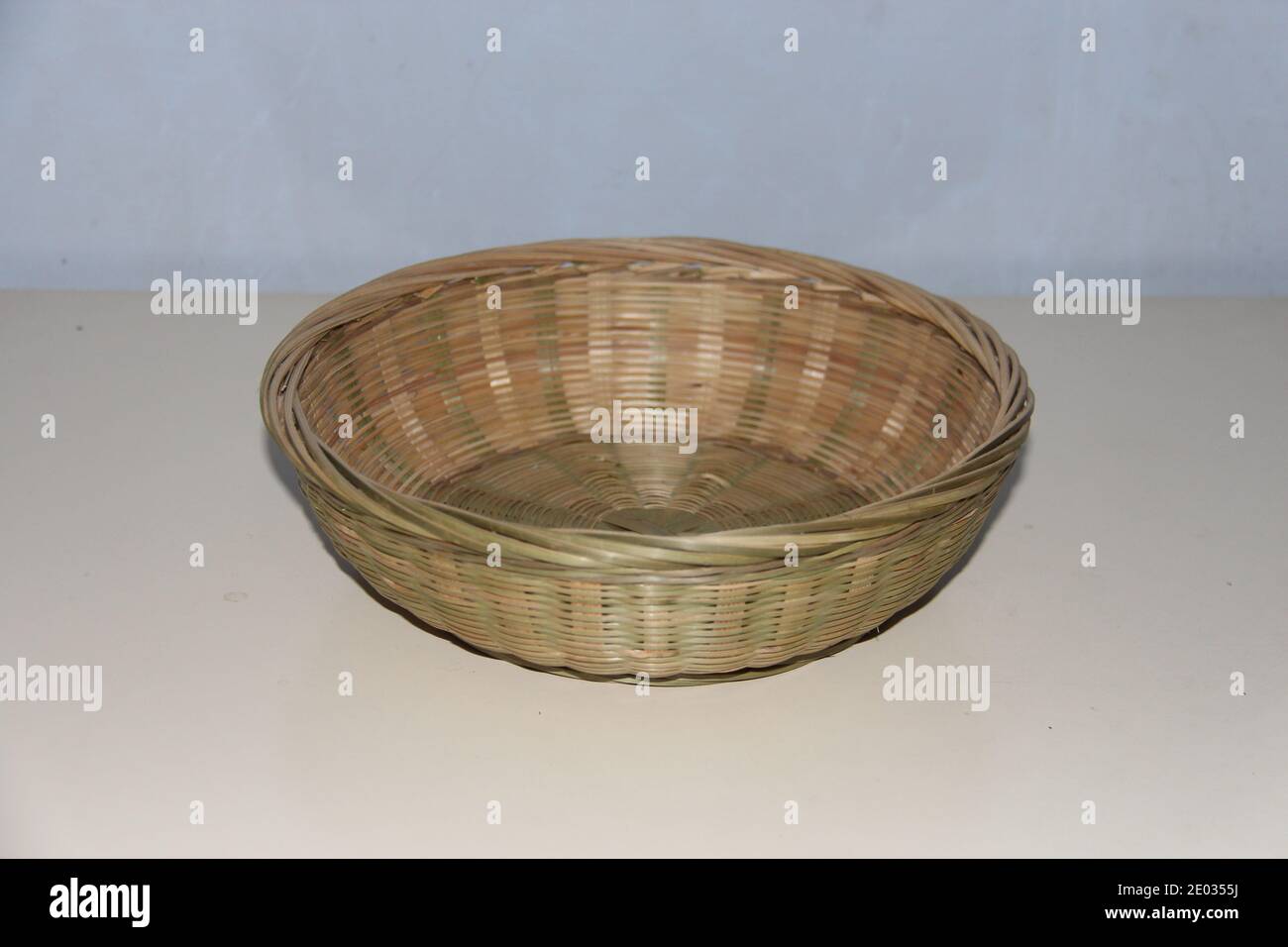 Empty handwoven round threshing basket with gray background Stock Photo ...