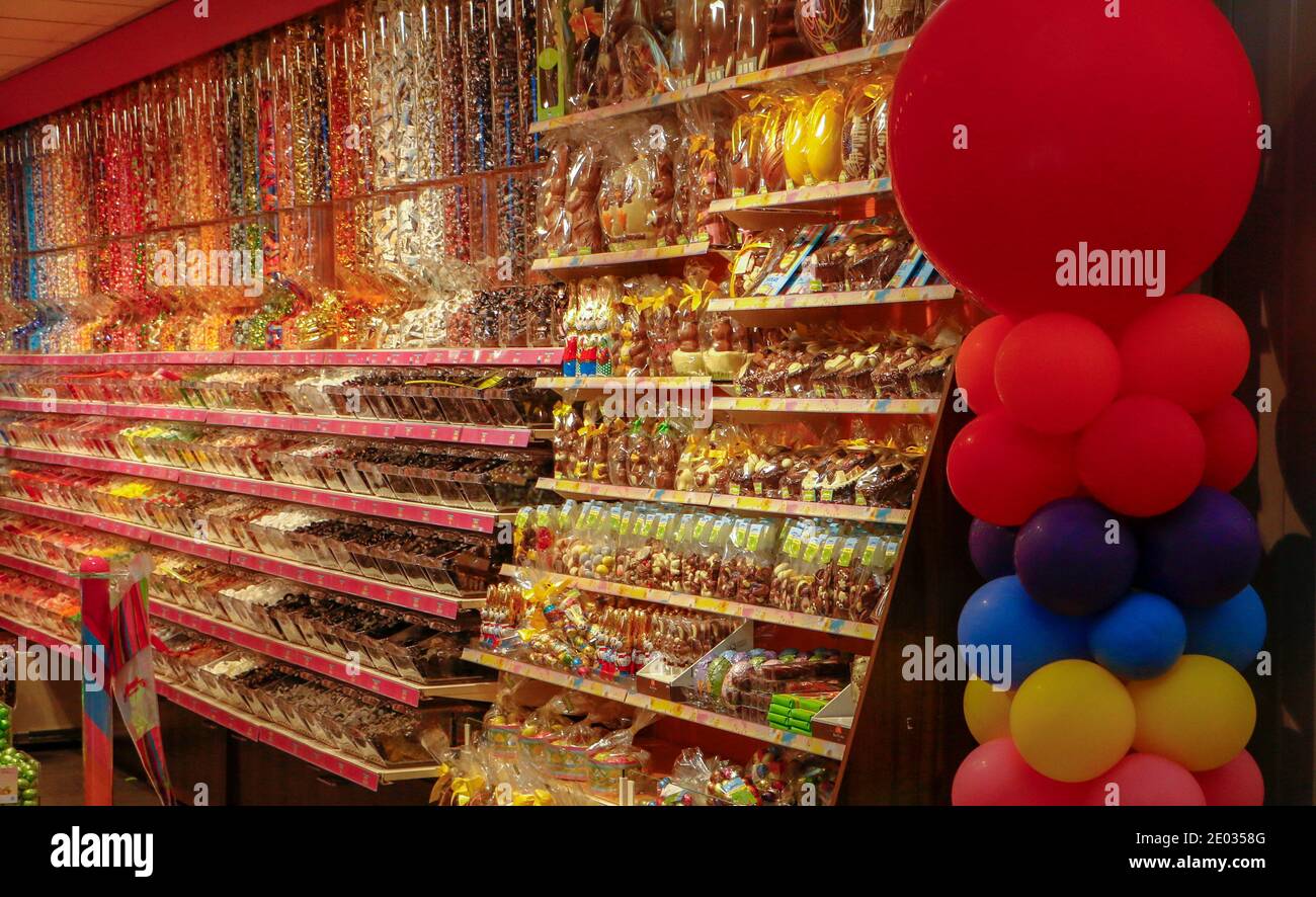Various sweets and snacks on the shelves. Interior of a sweet shop ...