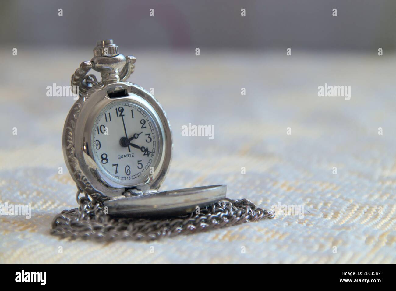 An open antique pocket watch with blurry background. A vintage clock ...