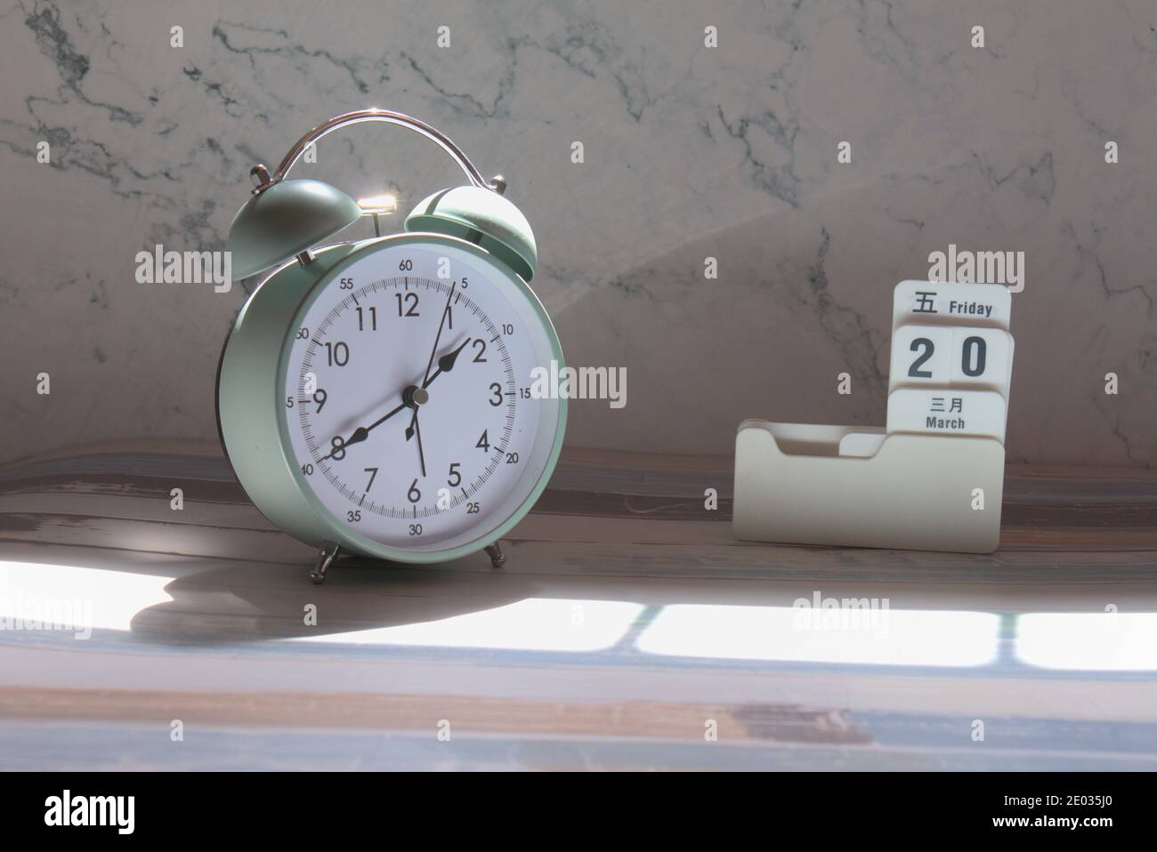 Vintage alarm clock and time notes under sunlight, time concept ...