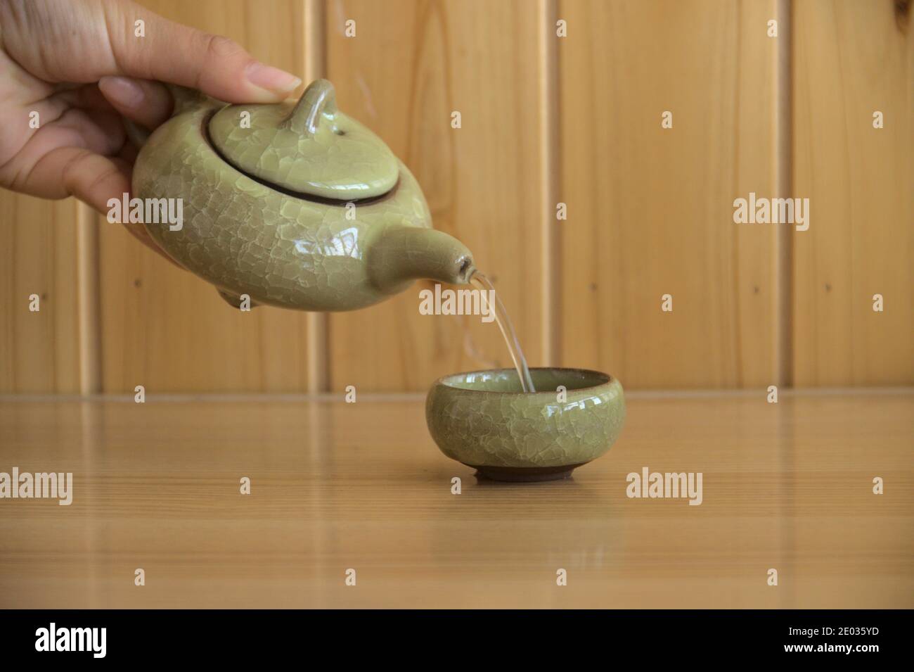 Closeup of pouring hot tea into the cup, hospitality etiquette, relax ...