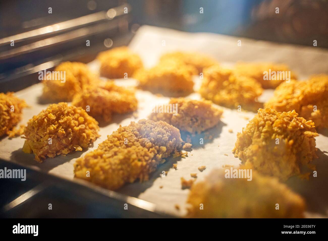 Chicken nuggets are baked in the oven Stock Photo - Alamy