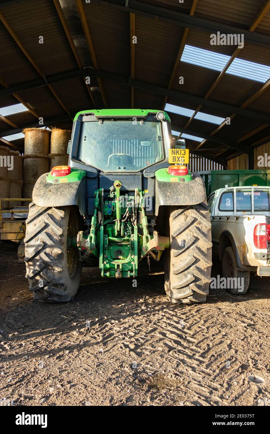 tractor farm vehicle in hay barn with bales on a northumberland farm ...