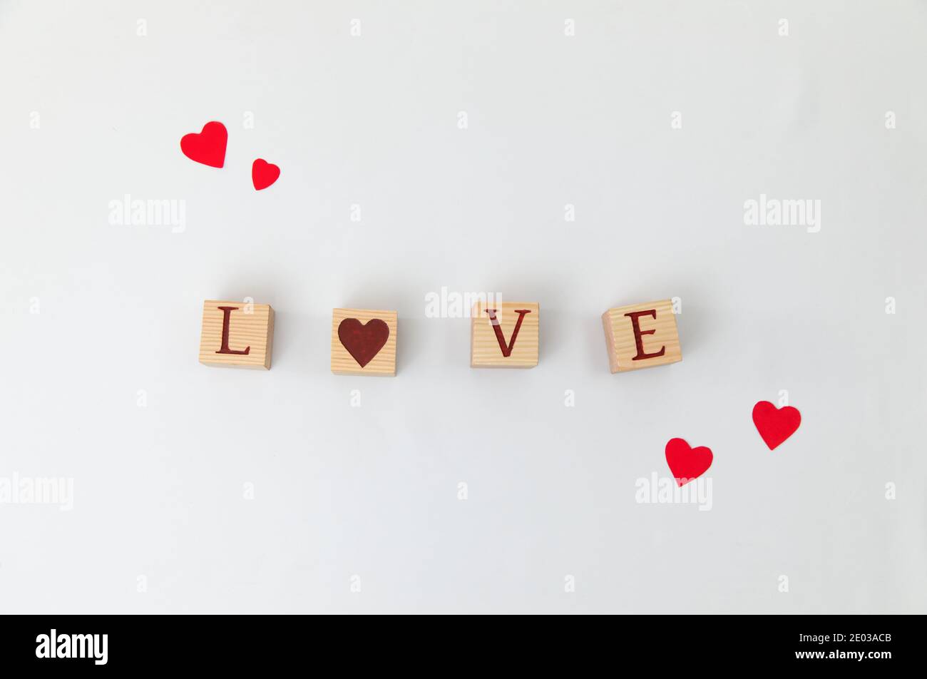Love word written with wooden blocks, red love decoration, white ...