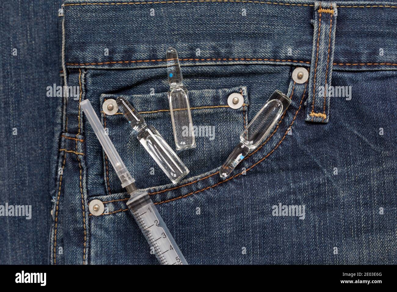 Injection syringe with ampullas are lying in side pocket of jeans ...