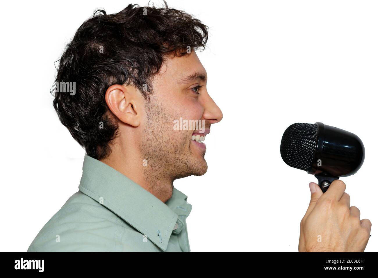 Profile of a young man in formal clothes smiling while using a ...
