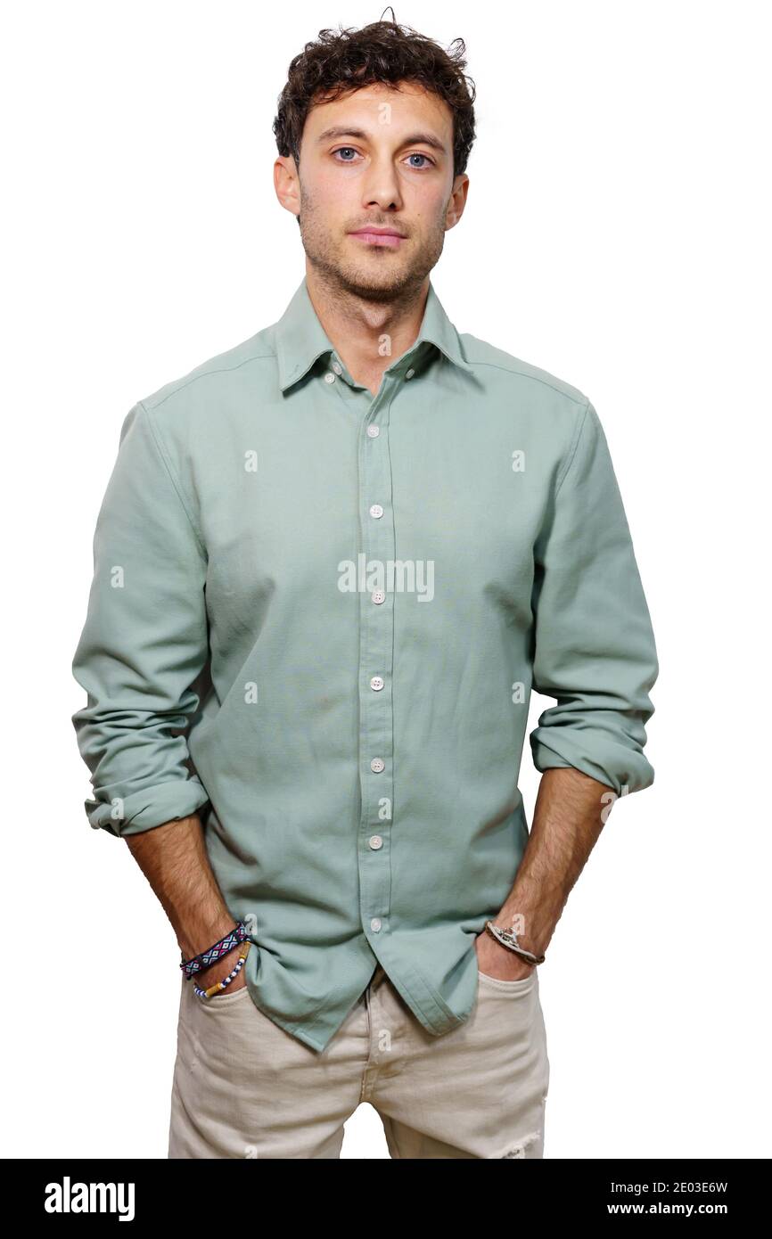 Vertical photo of a young man with shirt and the hands on the pockets ...