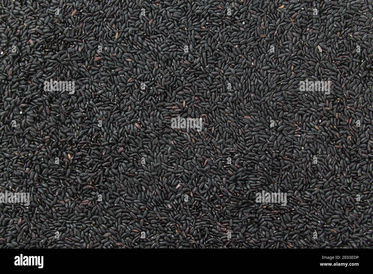 Raw dried black rice background Stock Photo - Alamy
