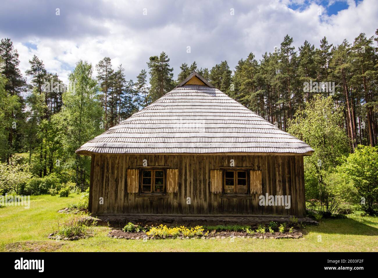 Fairytale baltic wooden house, sunny day, trees around Stock Photo - Alamy