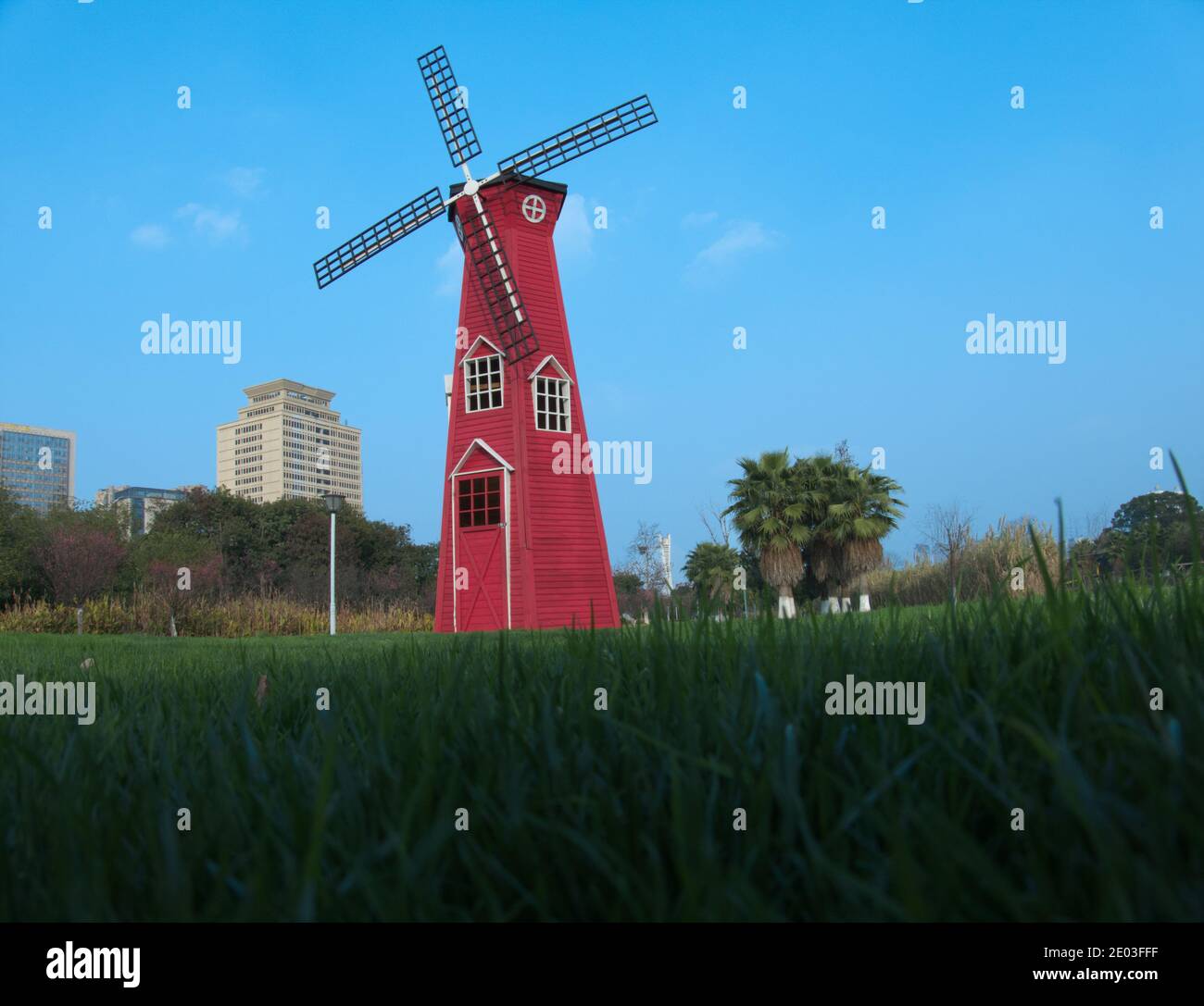Red windmill with wind in the park, renewable energy concept, nature ...