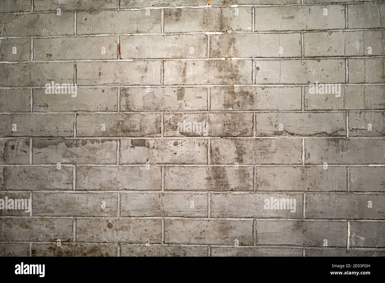 An old dirty brick wall of gray color . Background of a peeling white ...