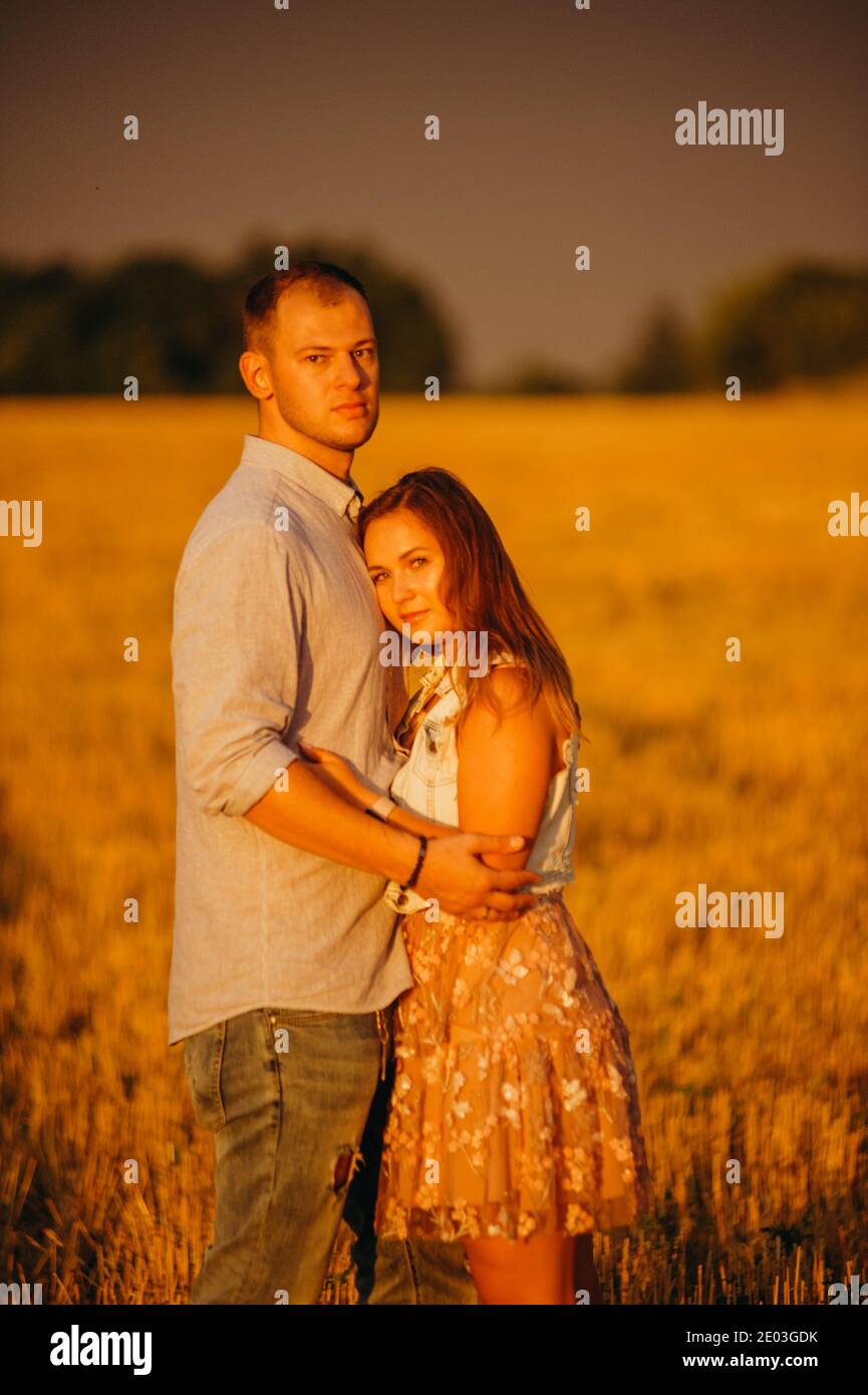 The concept of romantic relationships. A happy couple in a field in the ...