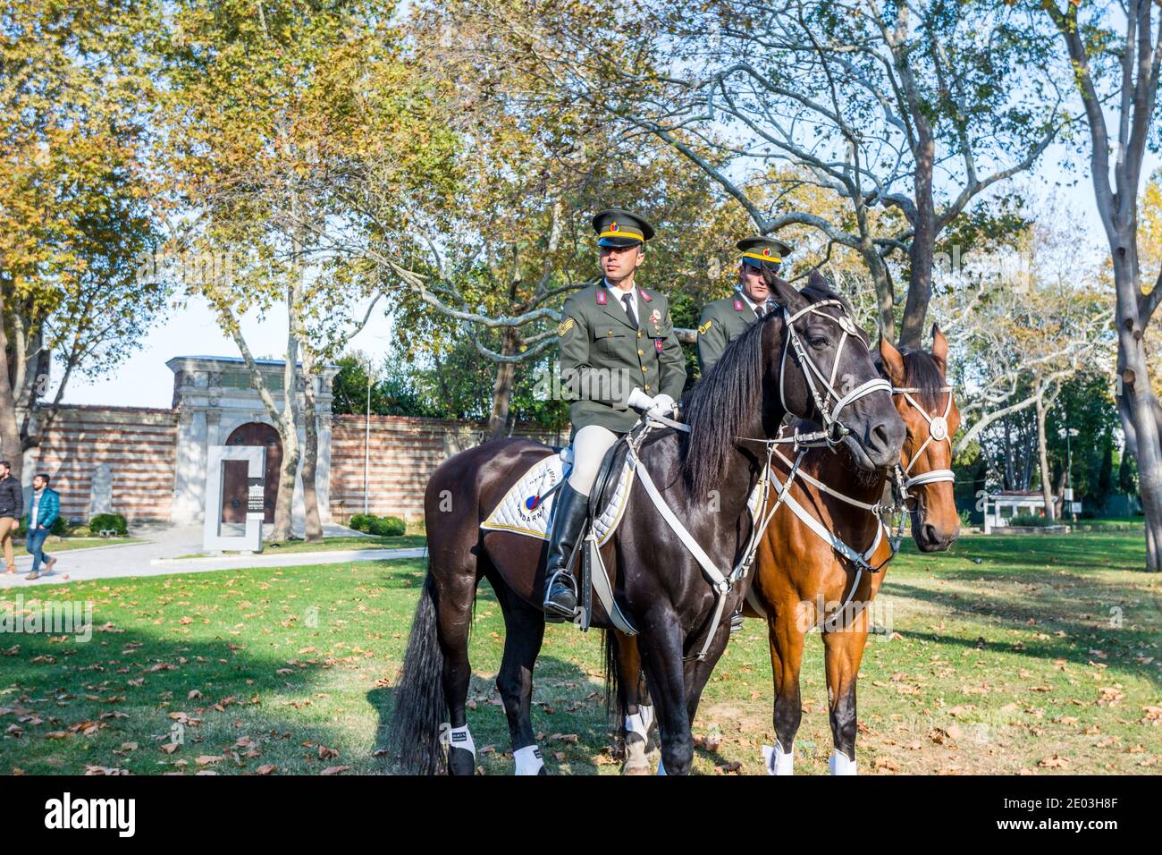 Two guards riding horses and wearing green uniform in the park Topkapi ...