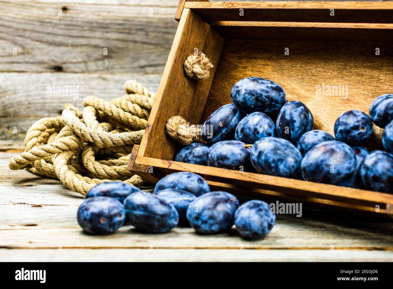 Ripe blue plums in a wooden crate in a rustic composition Stock Photo ...