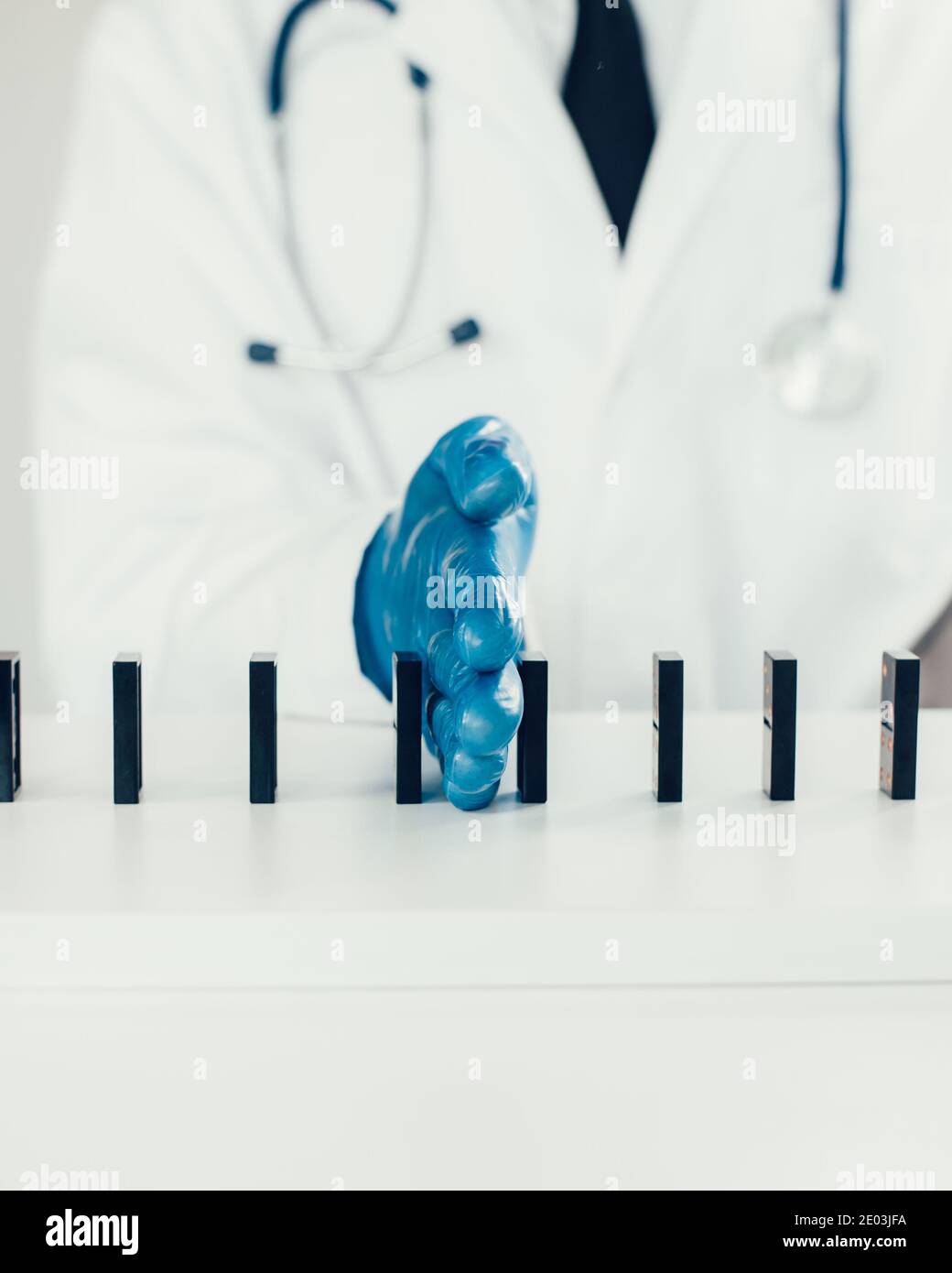 close up. doctor using dominoes to show a safe distance Stock Photo - Alamy