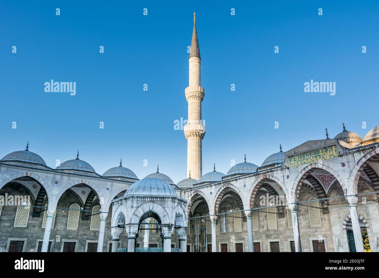 Single minaret against blue sky at the corner of blue Mosque also ...