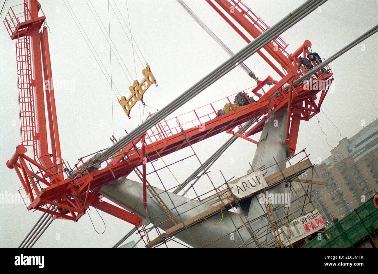Construction workers building the Millennium Bridge over the River ...