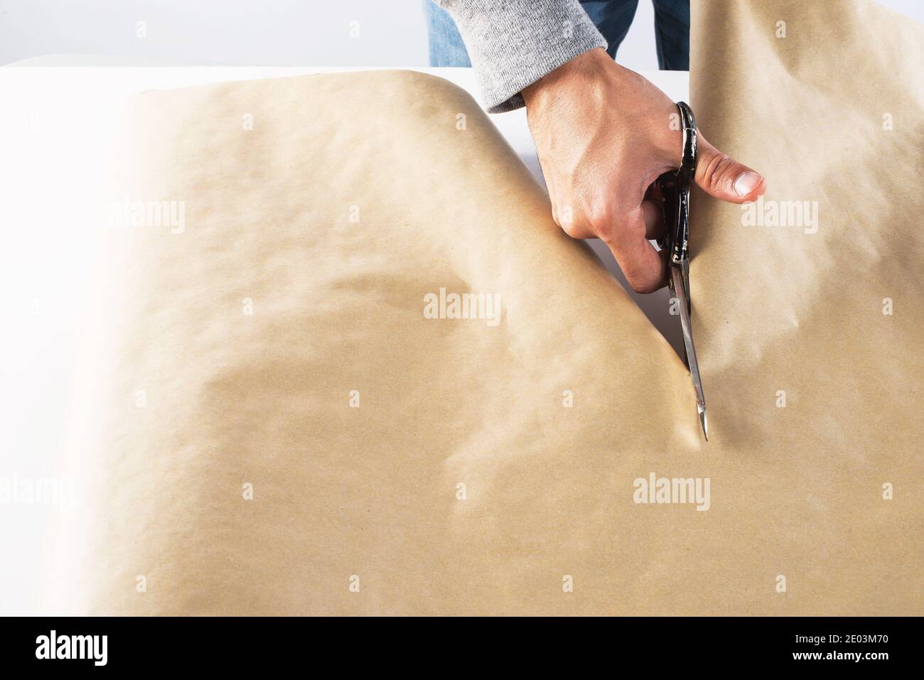cutting kraft paper on a white table Stock Photo - Alamy
