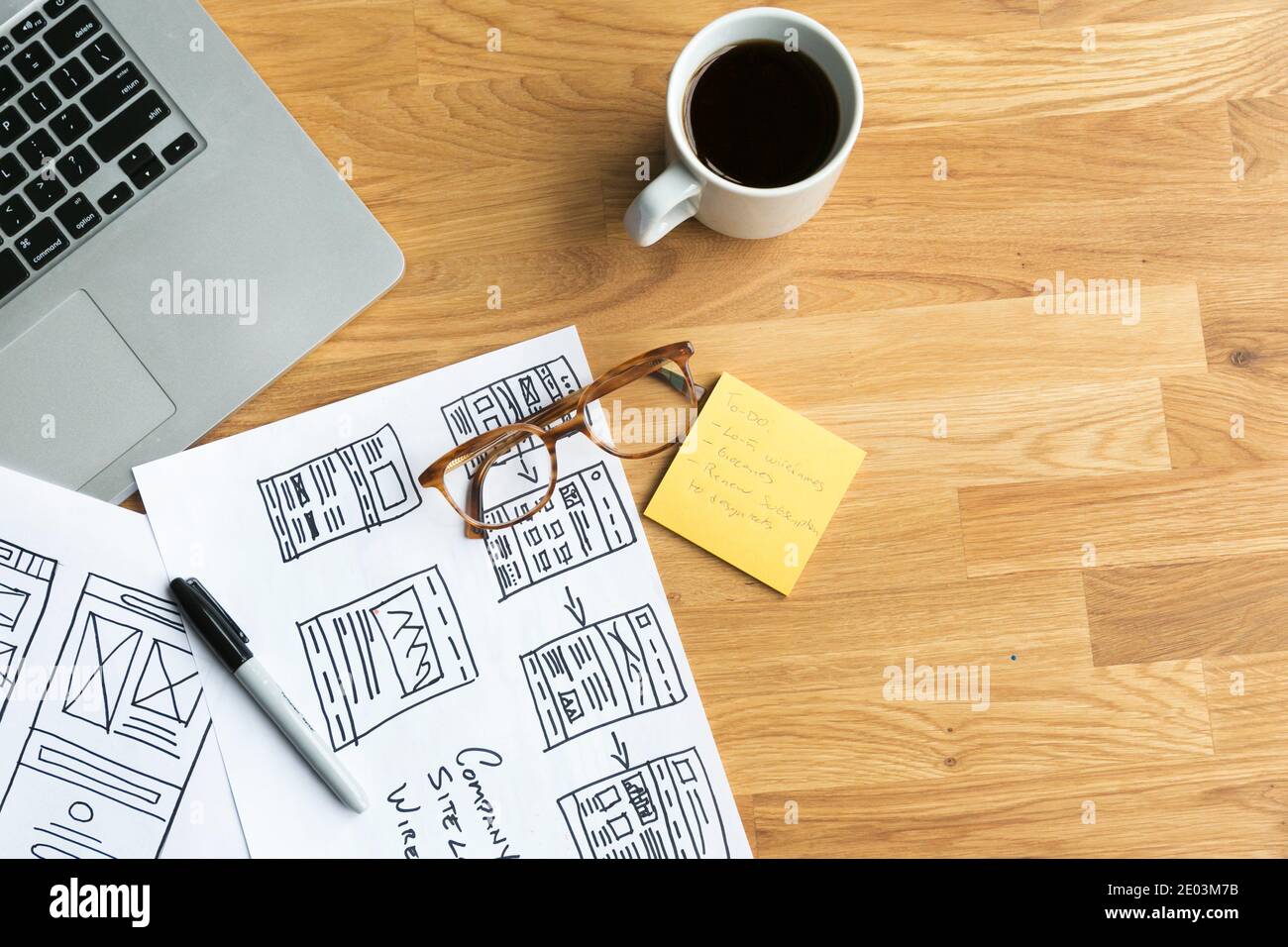 designers desk with coffee wireframes Stock Photo - Alamy