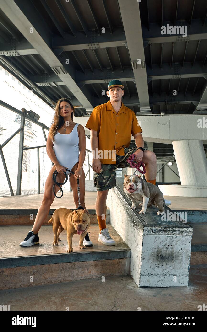 young stylishly dressed man and woman with an athletic figure with two ...