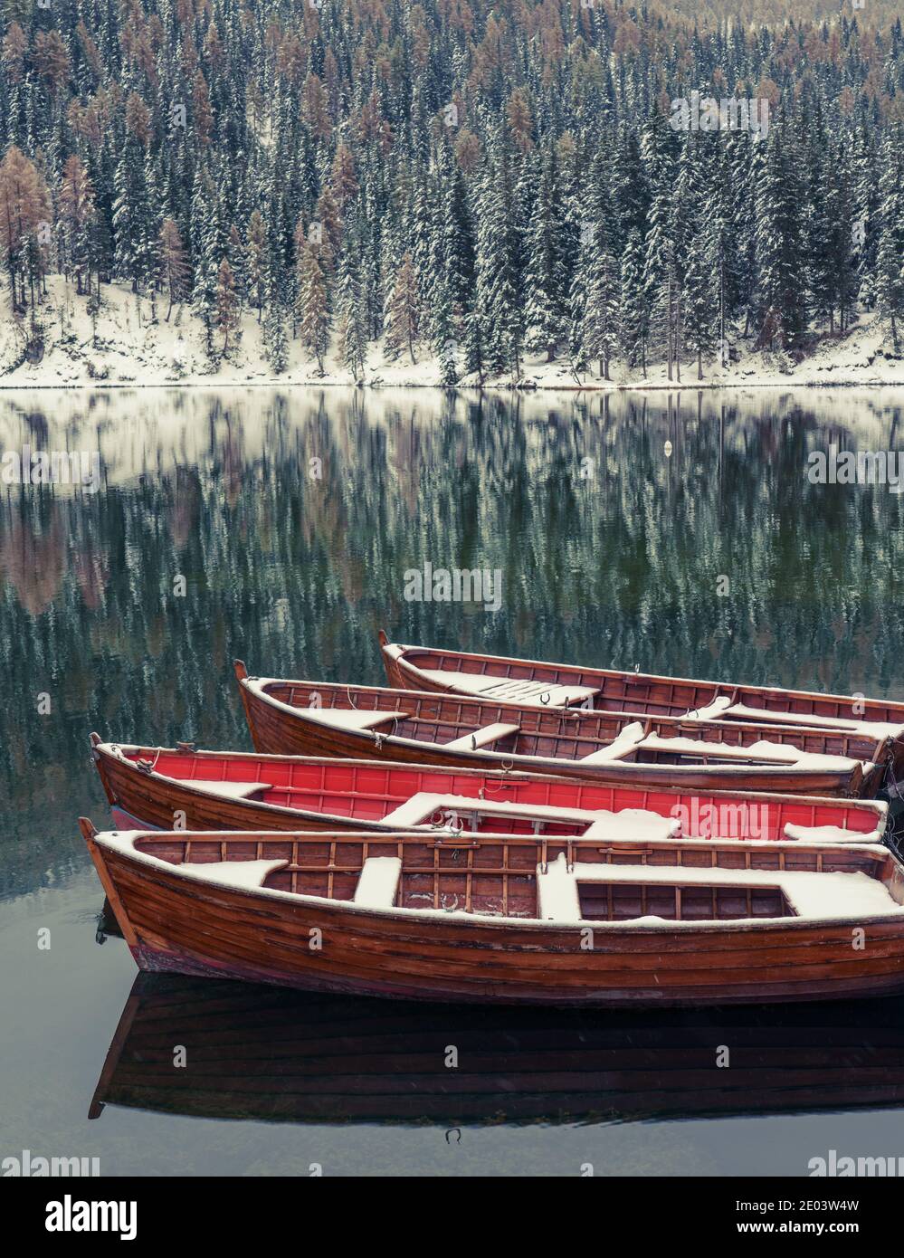 Snowy red boats on the mountain lake Misurina Italy Dolomites Stock ...