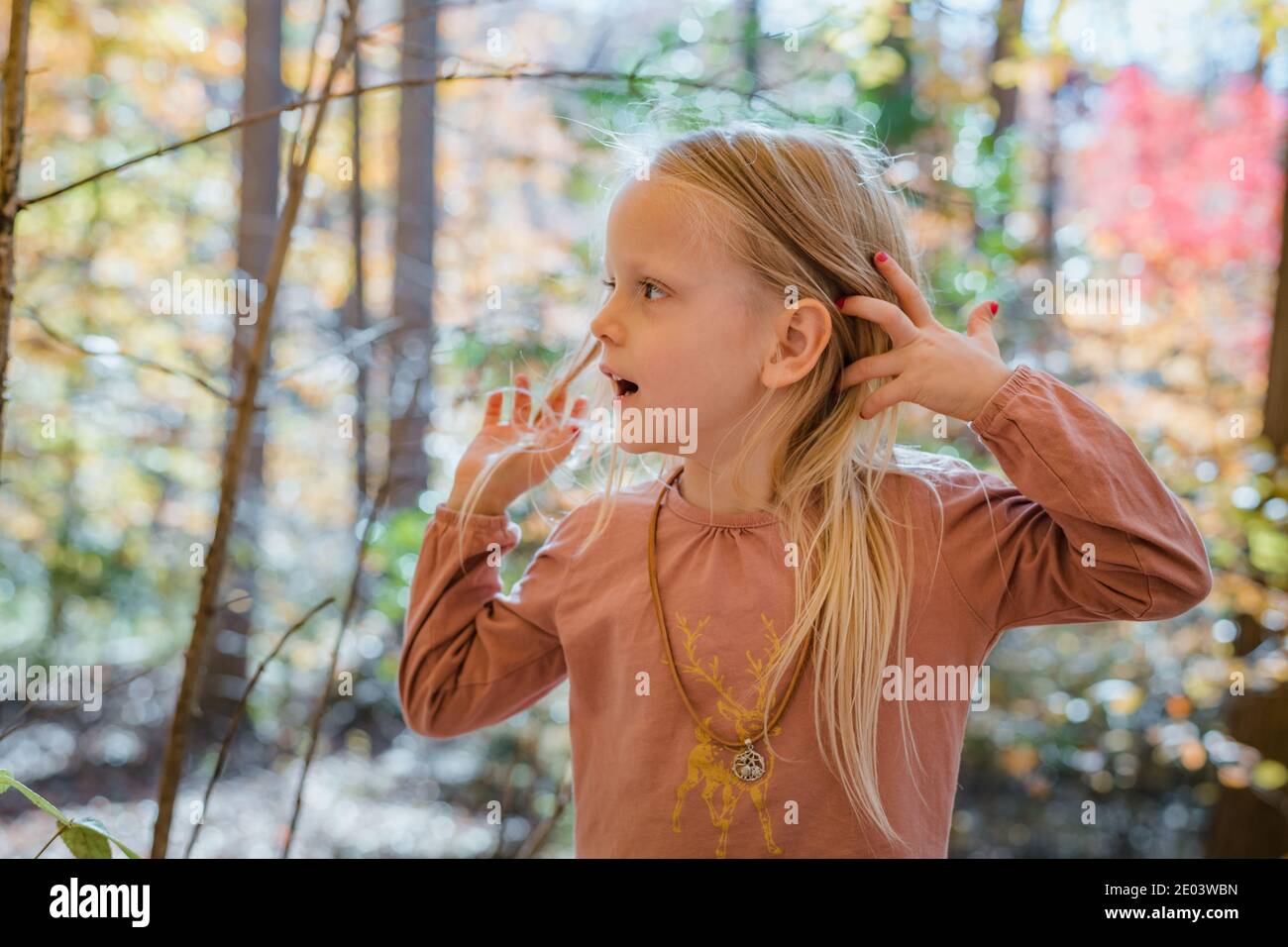 Little girl outside in forest with fall scenery Stock Photo - Alamy