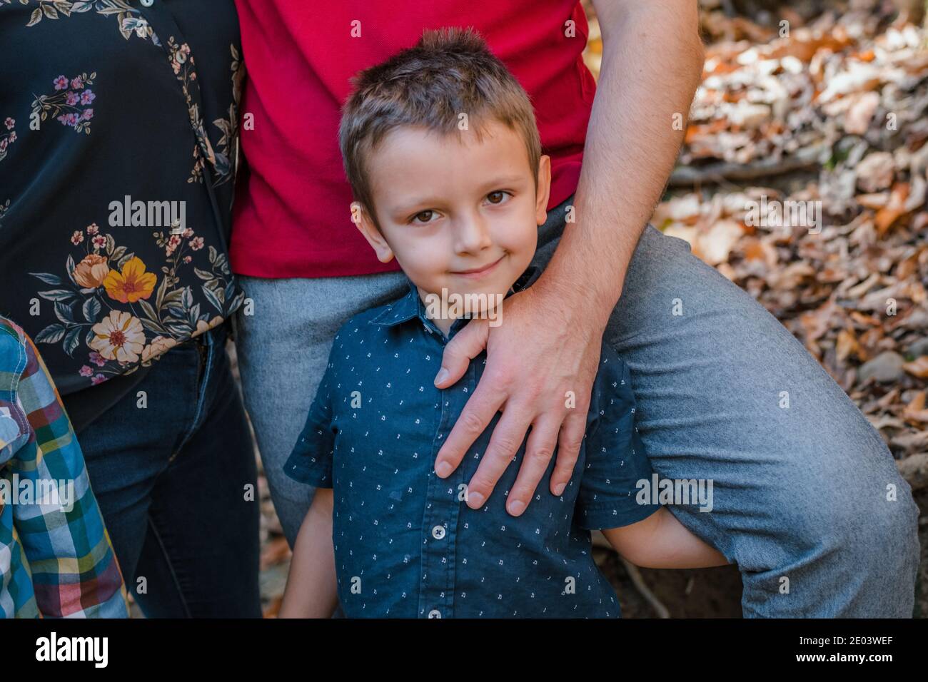 Little boy standing next to father Stock Photo - Alamy