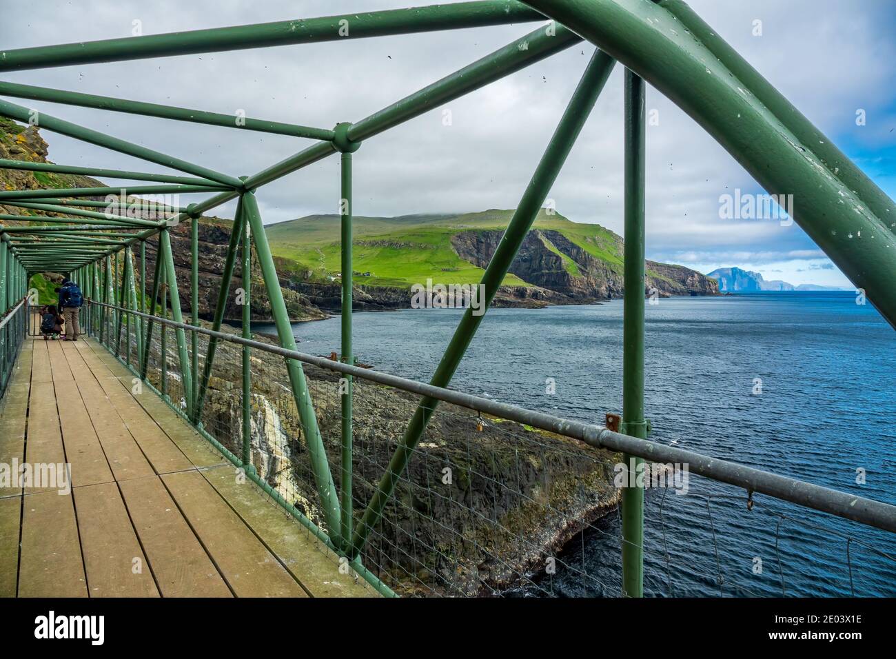 Iron bridge in the Mykines island with unrecognizable tourists Stock ...