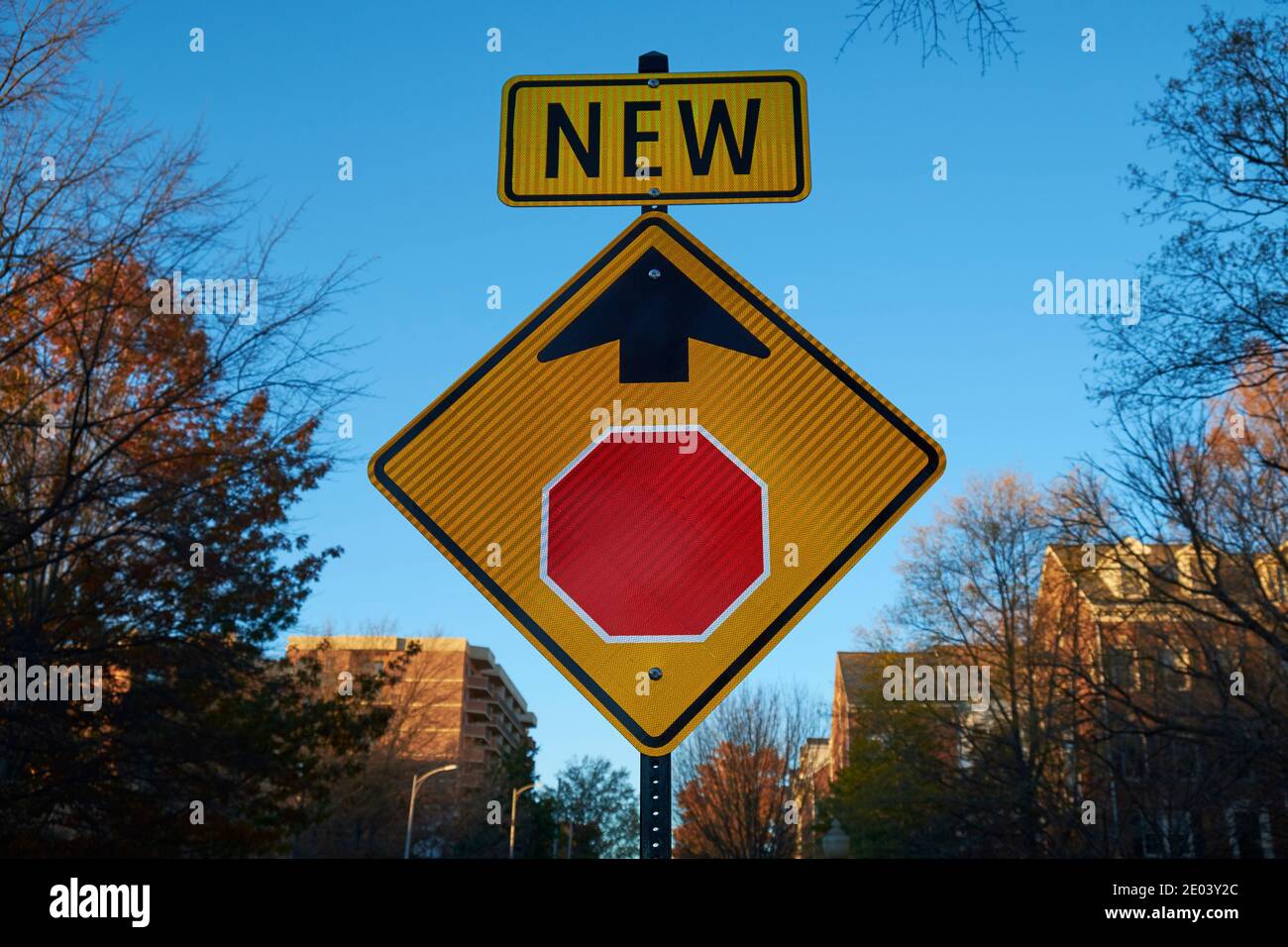 A metal yellow, diamond-shaped warning traffic sign for a new Stop sign ...