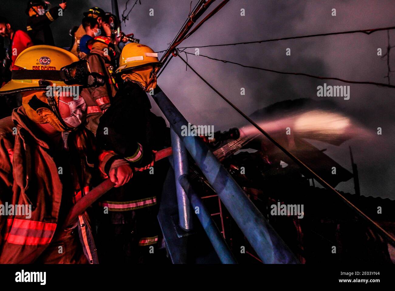 Manila, Philippines. 29th Dec, 2020. Firefighters put out a fire ...