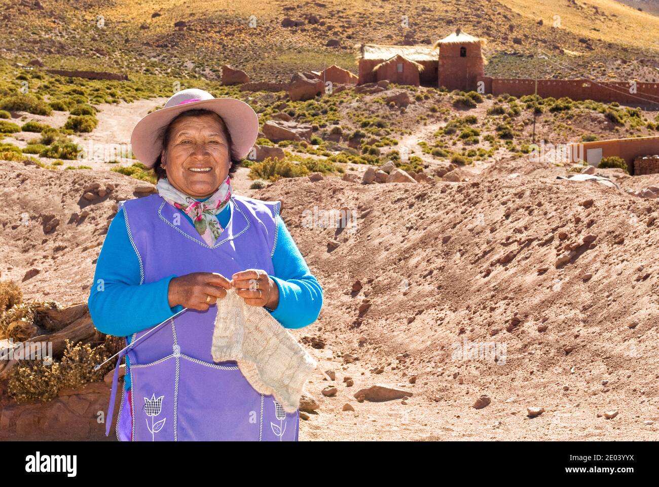Old lady from San Pedro de Atacama hand weaving and posing in front of ...