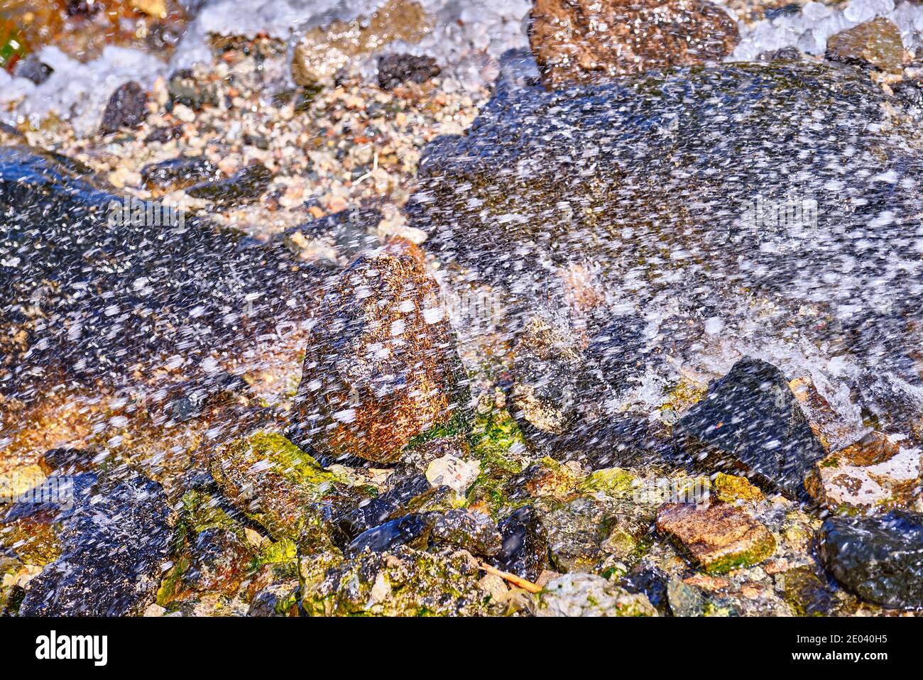Splendor and magic of water splashes on the background of multi-colored ...