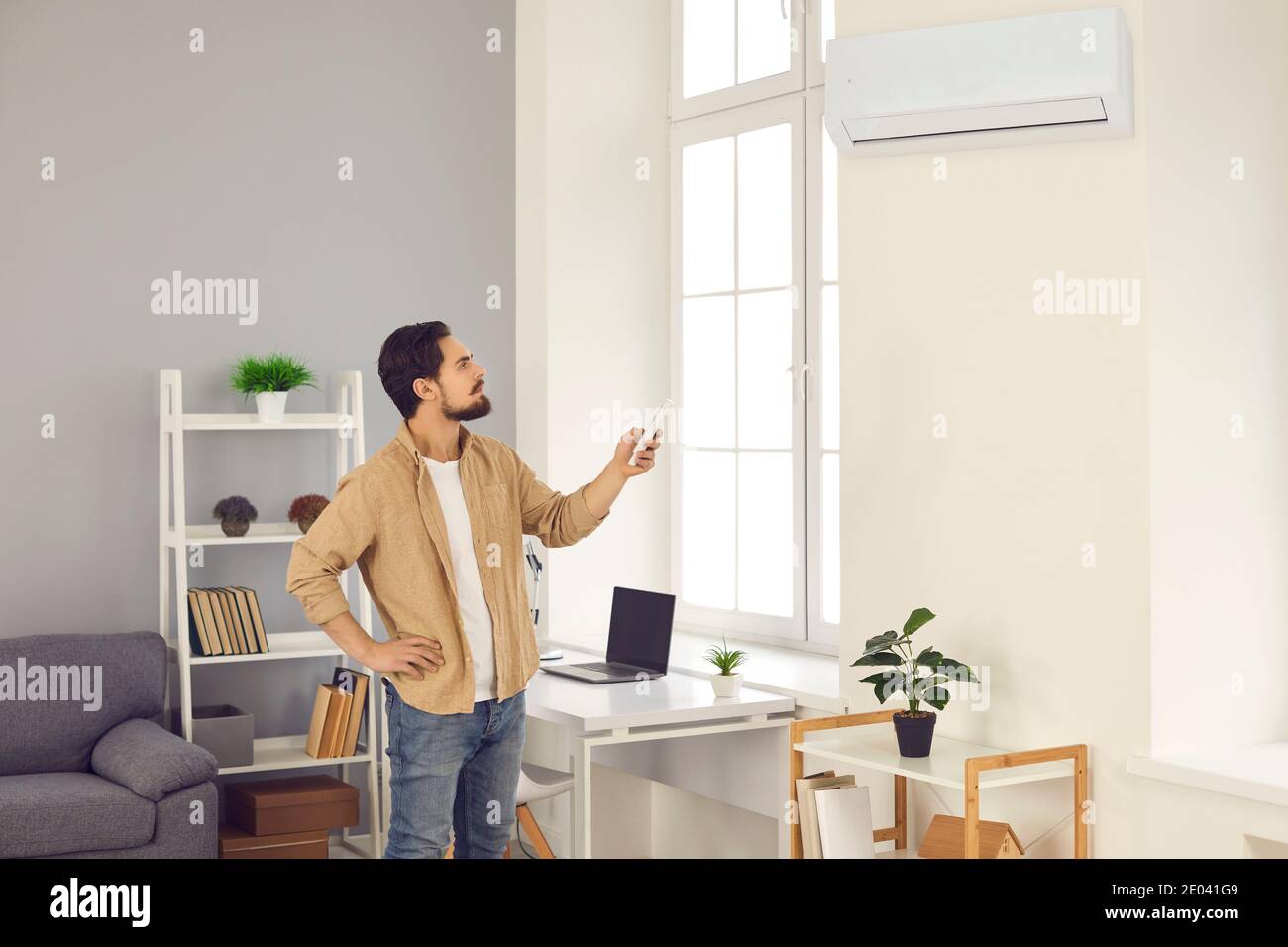 Person using remote control hi-res stock photography and images - Alamy