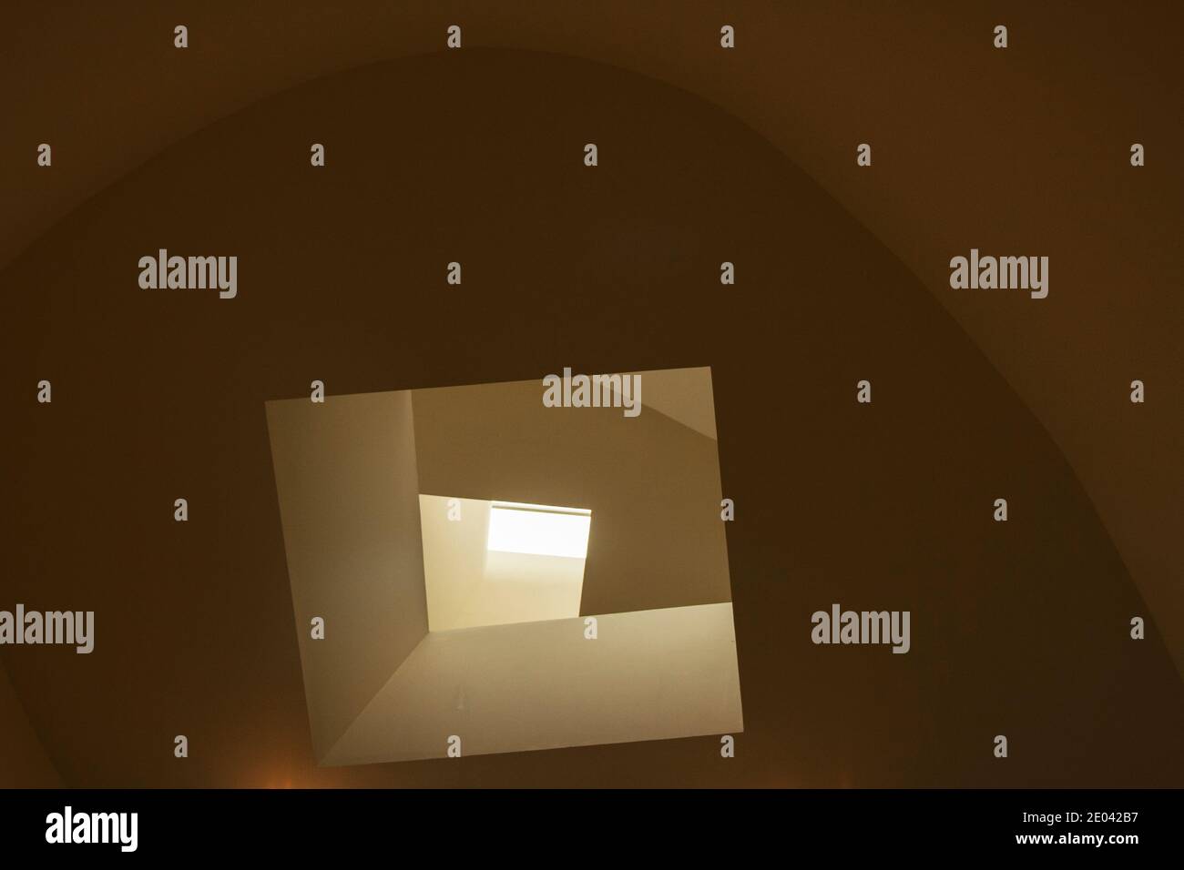 Sunlight shining in through a skylight of the building viewed from ...