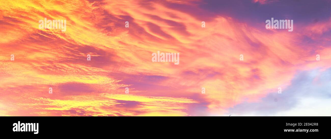 Cumulus sunset clouds with sun setting down Stock Photo - Alamy